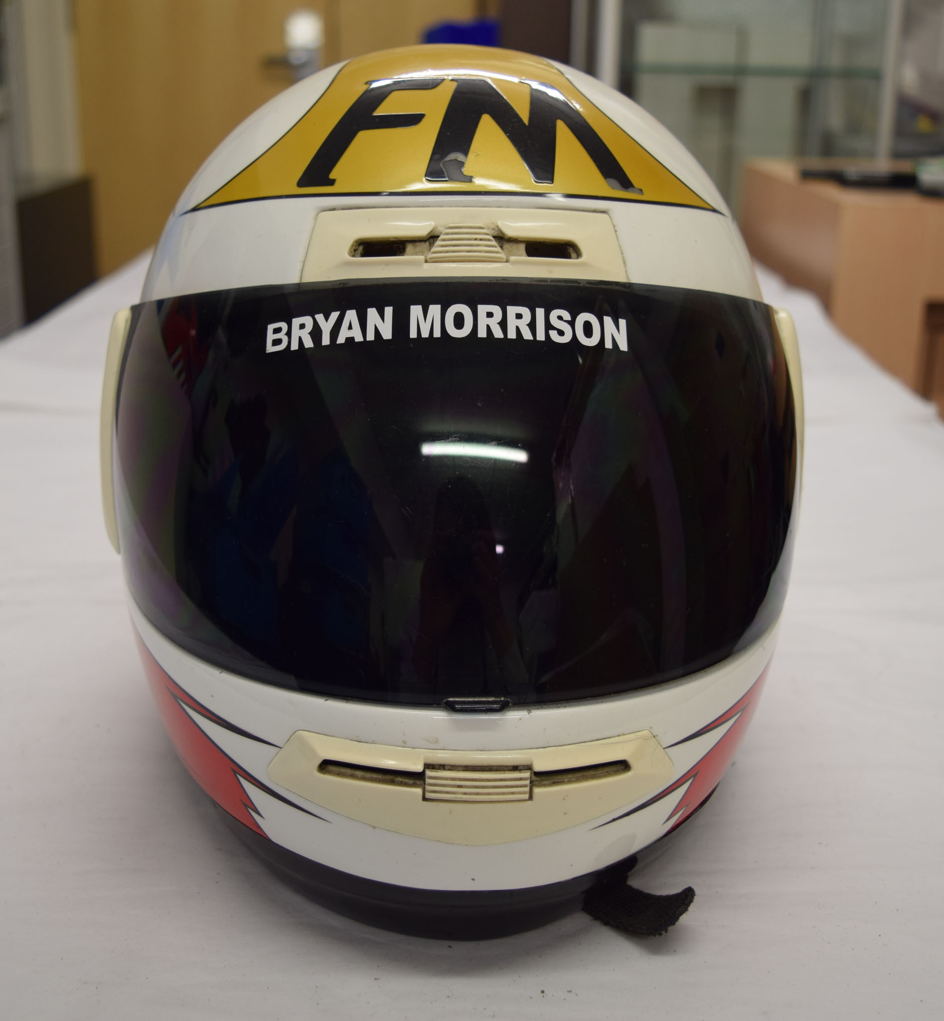 FM motorcycle helmet belonging to Brian Morrison. White helmet with ...