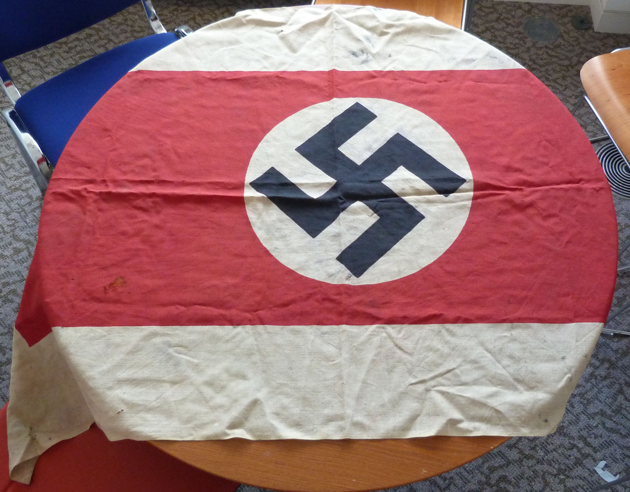 Nazi flag. Cream flag with large red stripe and swastika in the middle ...