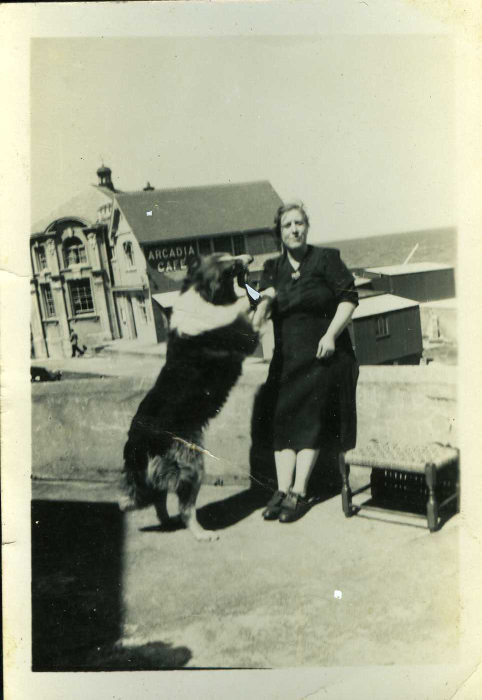 Black and white photograph of a lady and dog with the Arcadia Cafe ...
