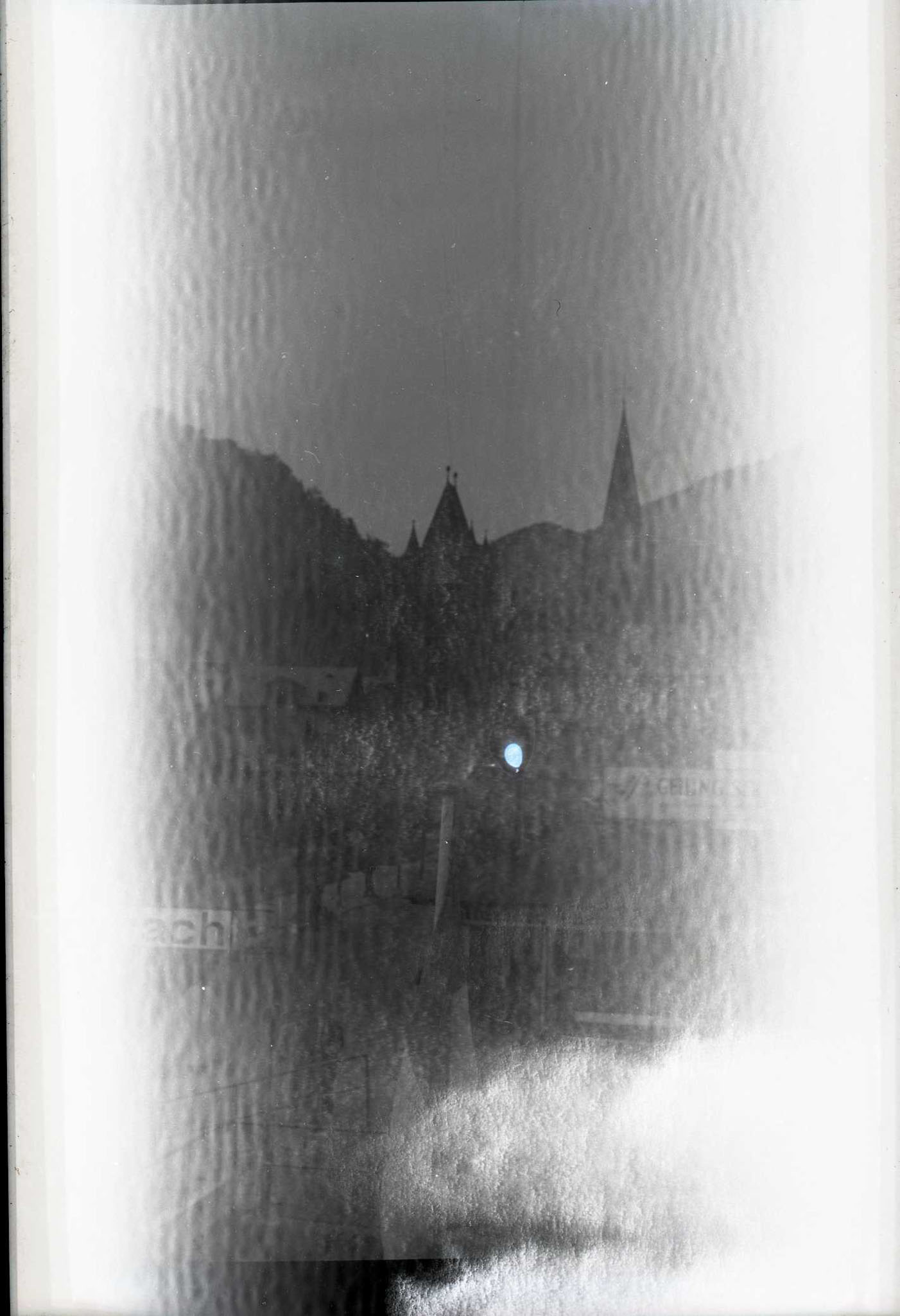Film negative. Poor quality photo showing buildings with spires ...